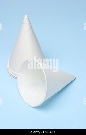 Disposable paper cone water cups with green leaf on pink background ...