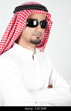 Young business man wearing glasses over isolated background Looking at ...