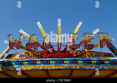 A waltzer fairground ride sign with lights Stock Photo - Alamy