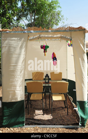 A traditional sukkah or succah temporary hut constructed topped with ...