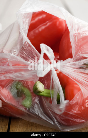 Red peppers in a plastic bag in front of white background Stock Photo ...