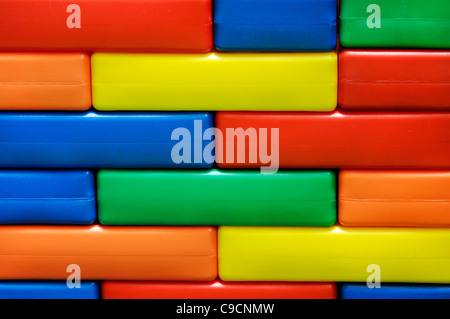 Baby toys on brick wall background Stock Photo - Alamy