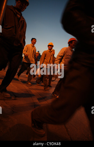Construction workers leaving construction site Stock Photo - Alamy