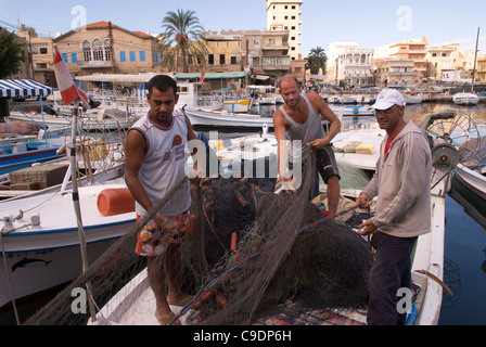 Fishermen tending their nets in the port of Tyre, southern Lebanon ...