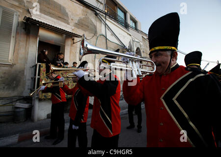 An Israeli Arab Christian marching band pass by a Muslim family during ...