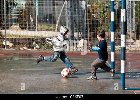 Jewish children playing football in Yericho settlement Stock Photo - Alamy