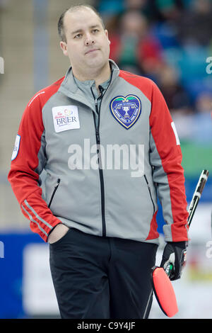 Northwest Territories skip Jamie Koe sweeps a rock in the house as they ...