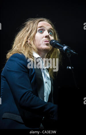 Tim Minchin, comedian and musician, performing on stage with his band ...