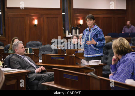 House Majority Leader Charisse Millett, R-Anchorage, left, helps pin a ...