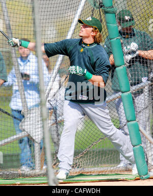 Oakland Athletics outfielder Travis Buck, left, stretches during Spring ...