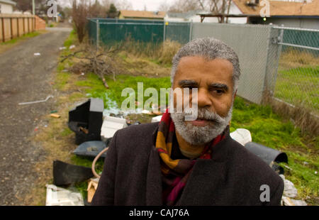 BUDGET REACT - Robbin Ware, walks near a pile of trash in an alley near ...