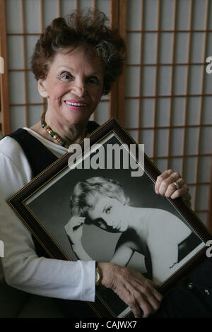 Elaine Dundy, 80, poses with an old photo of herself in the 1950s, at ...
