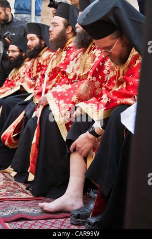 Barefooted priests await their turn in the traditional Washing of the ...