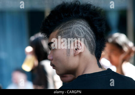 Young man with a Mohawk hairstyle celebrating his graduation isolated ...