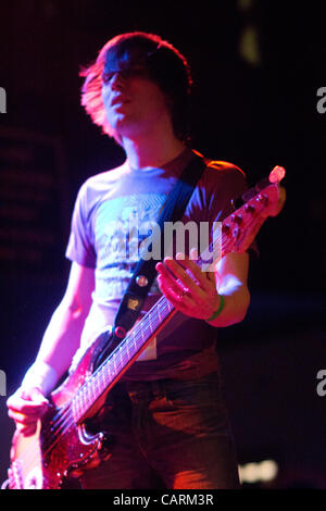 Close up of bassist and vocalist Gary Jarman as he performs to an ...