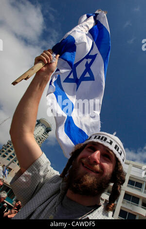 A religious Jewish man dance while waving Israeli flag at the seacoast ...