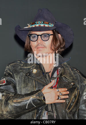 Fans of American director Johnny Depp cheer him on outside a cinema as ...