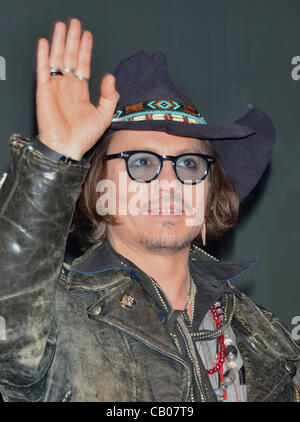 Fans of American director Johnny Depp cheer him on outside a cinema as ...