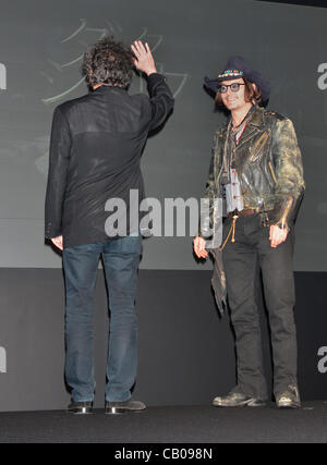 Fans of American director Johnny Depp cheer him on outside a cinema as ...