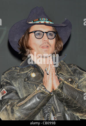 Johnny Depp acknowledges the cheers of his fans as he goes outside ...