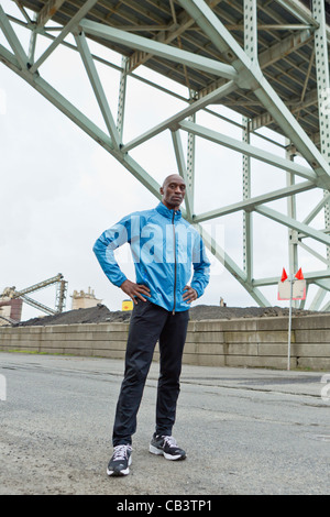 Man standing beneath bridge Stock Photo - Alamy