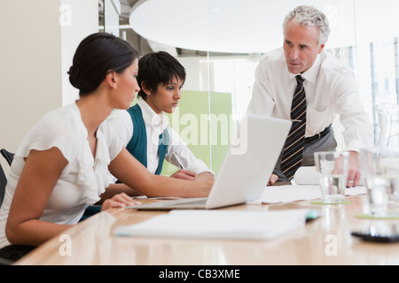 Project discussions amongst employees in boardroom Stock Photo - Alamy