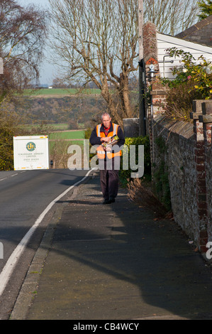 postman walking the street delivering mail Stock Photo - Alamy