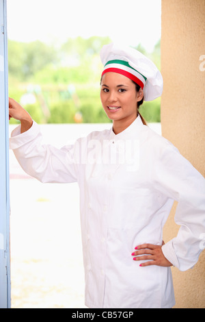 Young female chef on pink background Stock Photo - Alamy