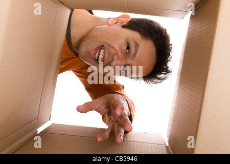 Hand reaching from inside recycling receptacle, holding plastic Stock ...
