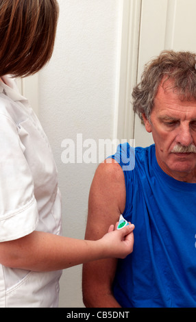 Nurse Placing Digital Thermometer Under A Patient's Arm Taking ...