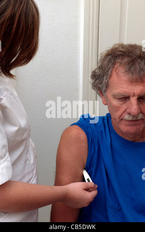 Nurse Placing Digital Thermometer Under A Patient's Arm Taking ...