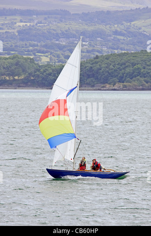 A sailing dinghy on the Menai Straits off Beaumaris on Anglesey, North ...