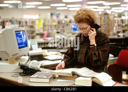Attractive female librarian at work Stock Photo - Alamy