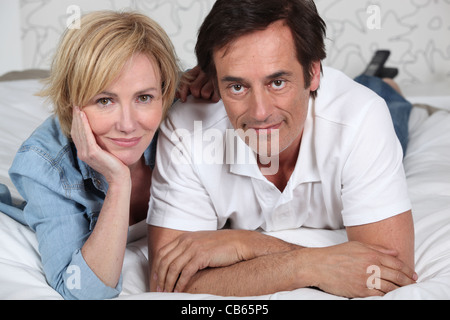 woman laid on her bed with crossed legs Stock Photo - Alamy