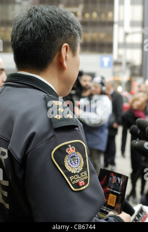 Vancouver Police Chief Jim Chu giving an interview to a street reporter ...