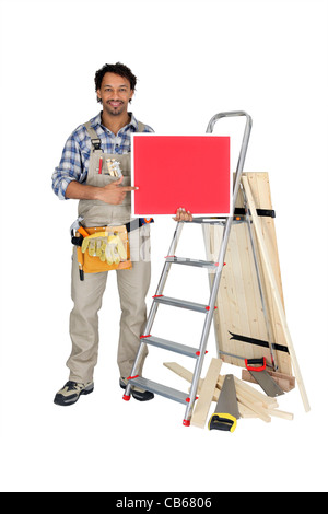 carpenter holding red sign Stock Photo - Alamy