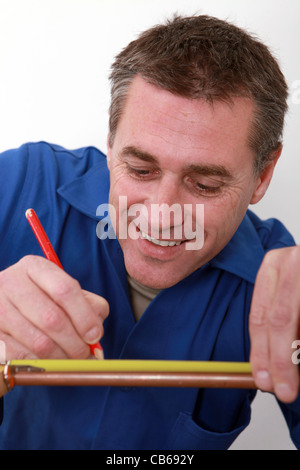 Plumber measuring copper pipe Stock Photo - Alamy