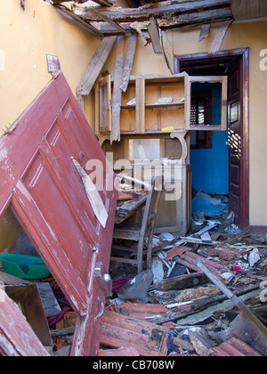 Inside an house destroyed by an earthquake: a collapsed wall, a ...