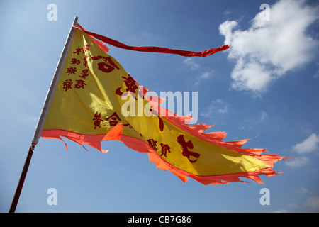 yellow triangular taoist flag flying outside shui sin temple stanley ...