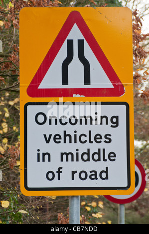 Warning sign of oncoming Vehicles in middle of road Stock Photo - Alamy