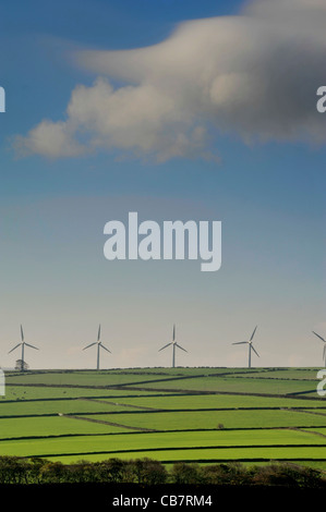 A wind farm with five wind turbines on a hill. The wind farm is located ...