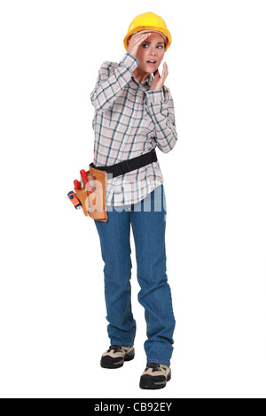 A horrified female construction worker Stock Photo - Alamy