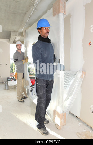 African-american man builder carrying metallic profile while working in ...