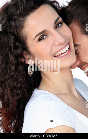 Loving her curls. an attractive young woman posing against a colorful ...