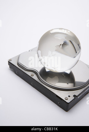 Glass globe on hard disk Stock Photo - Alamy