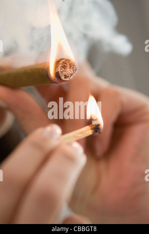 Closeup of woman lighting cigarette Stock Photo - Alamy