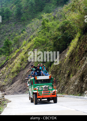 Philippines Overloaded jeepney truck with passengers on roof drives ...