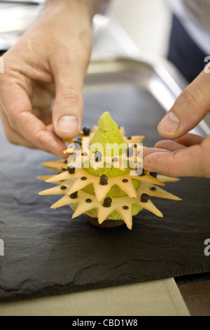 Chef assembling dessert shaped like Christmas tree Stock Photo - Alamy