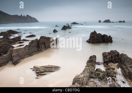 A long exposure image of the sea washing in around rocks at Porth Nobla ...