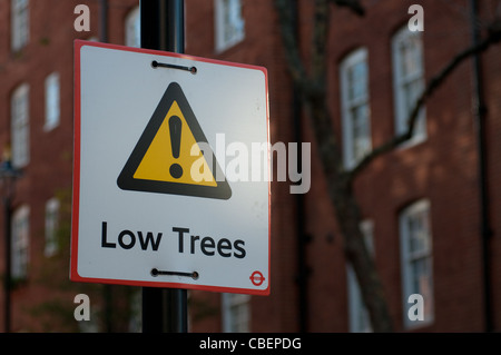 A warning sign about low trees in London, UK Stock Photo - Alamy